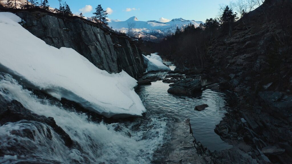 Nature sound of a loud waterfall flowing down the wet forest